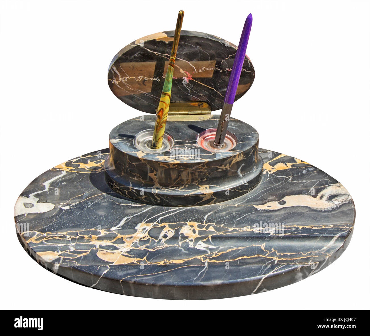 Old vintage pens on a stone stand, isolated on white background with ...