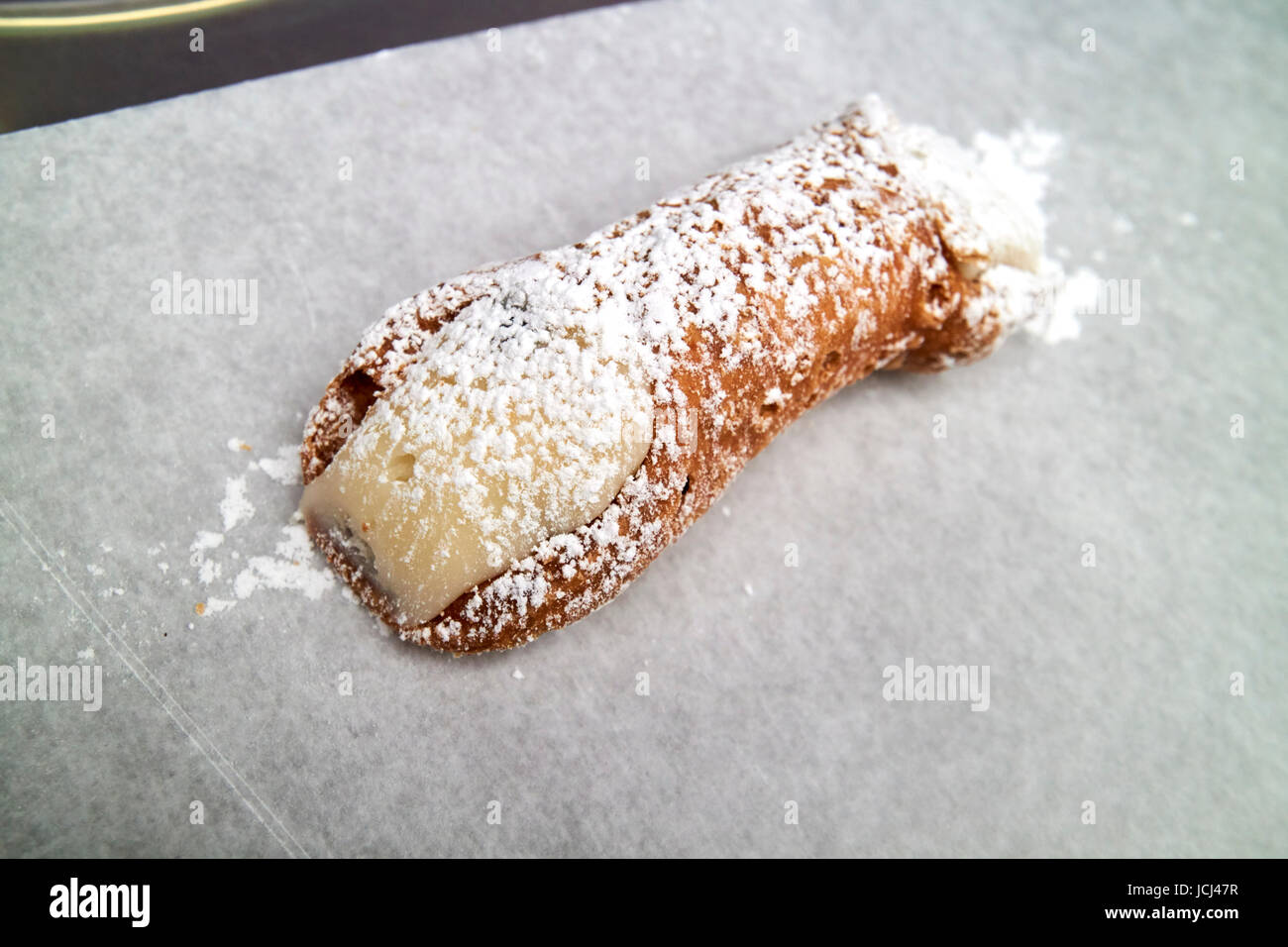 single cannolo lightly sprinkled with sugar italian cannoli little ...