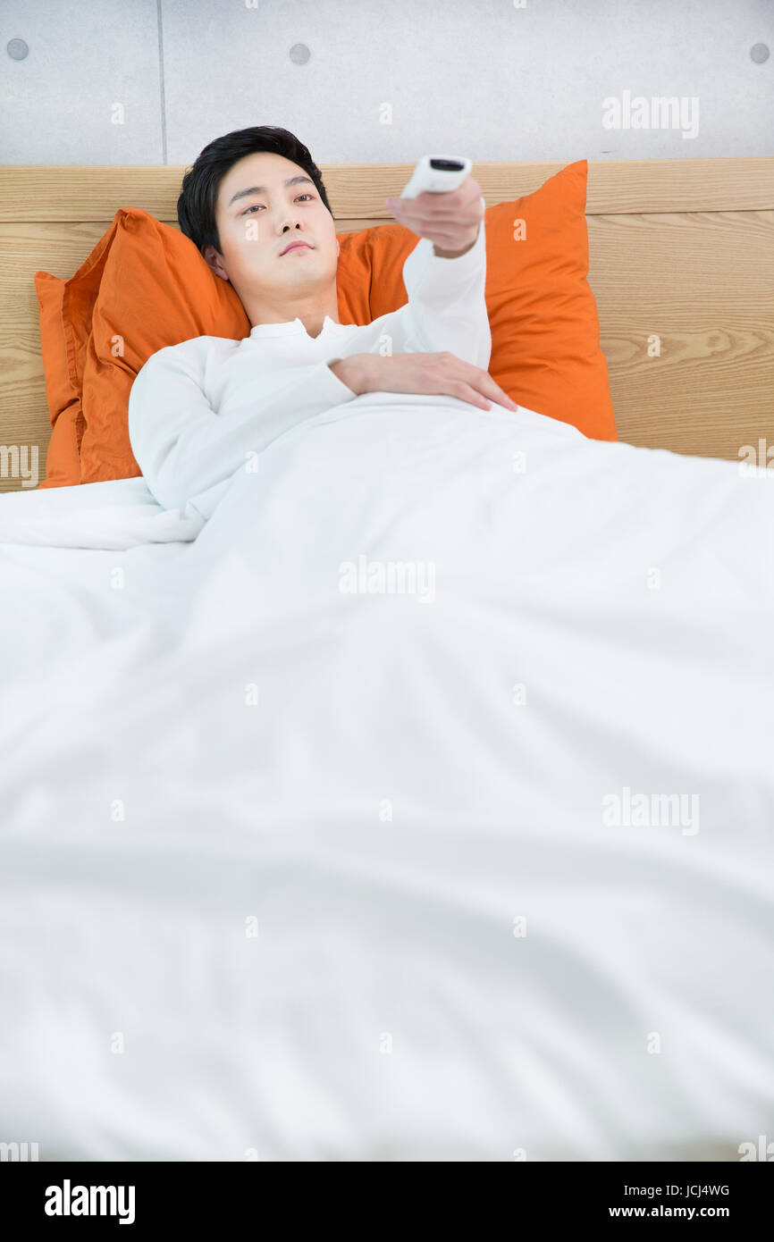 Person using remote control hi-res stock photography and images - Alamy