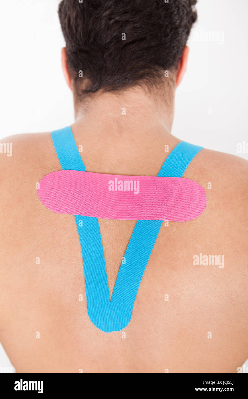 Rear View Of Young Man With Physio Tape Applied On Back Stock Photo - Alamy
