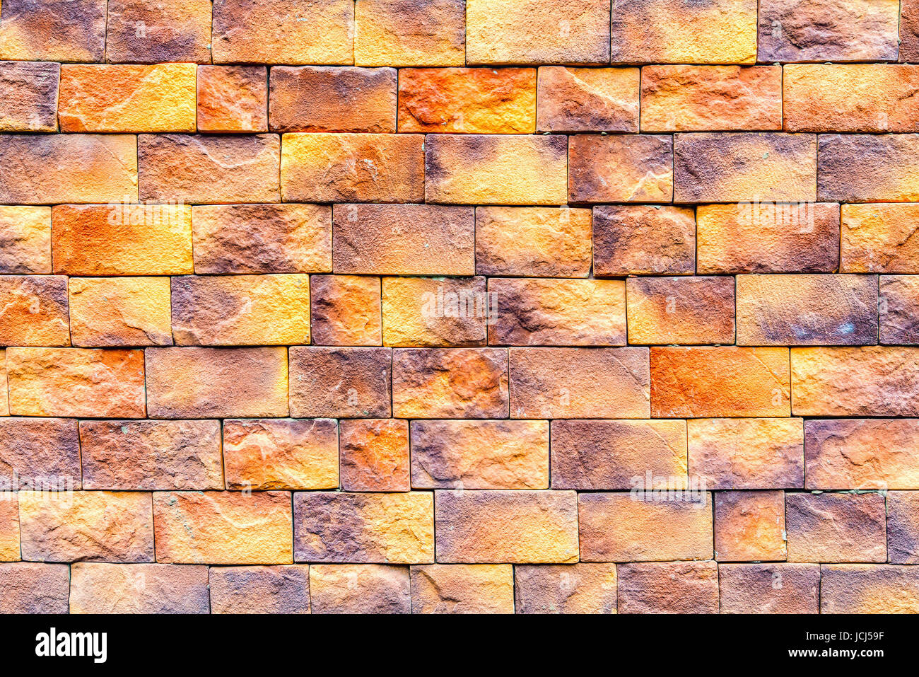 Colorful brick wall background on sunny summer day Stock Photo - Alamy