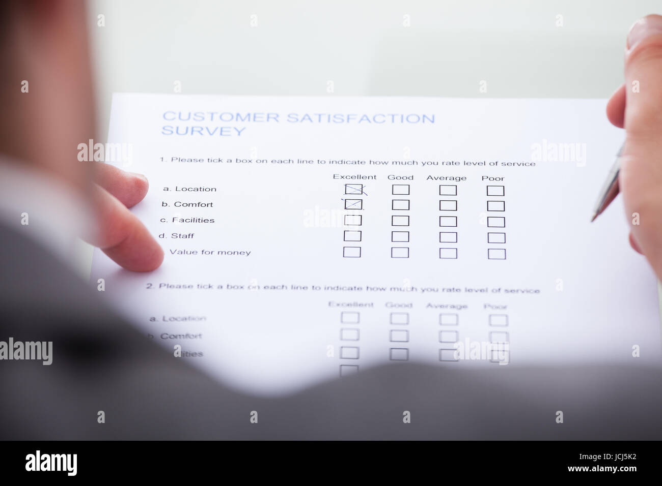 Close-up Of Businessman Filling Customer Survey Form Stock Photo - Alamy