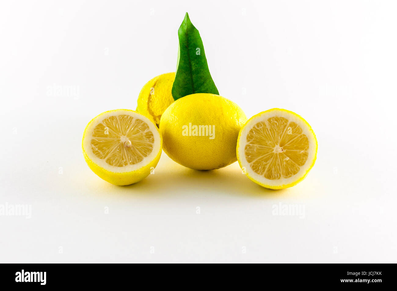 Fresh lemons yellow and green on white background Stock Photo - Alamy