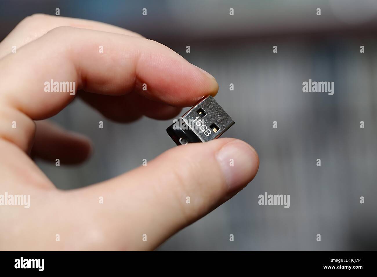 Tiny USB drive being held Stock Photo - Alamy