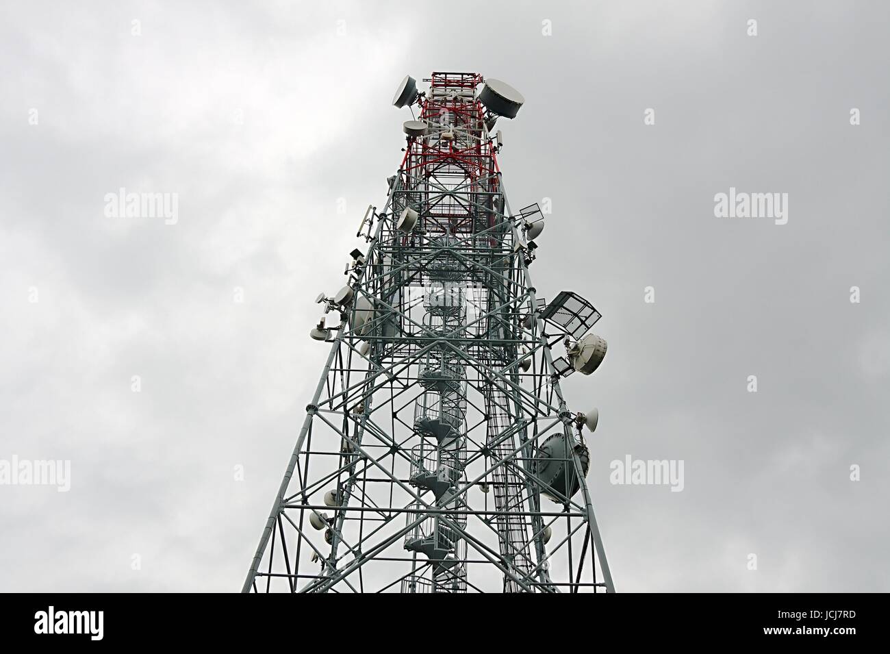 Communication transmitter tower against clear blue sky Stock Photo - Alamy
