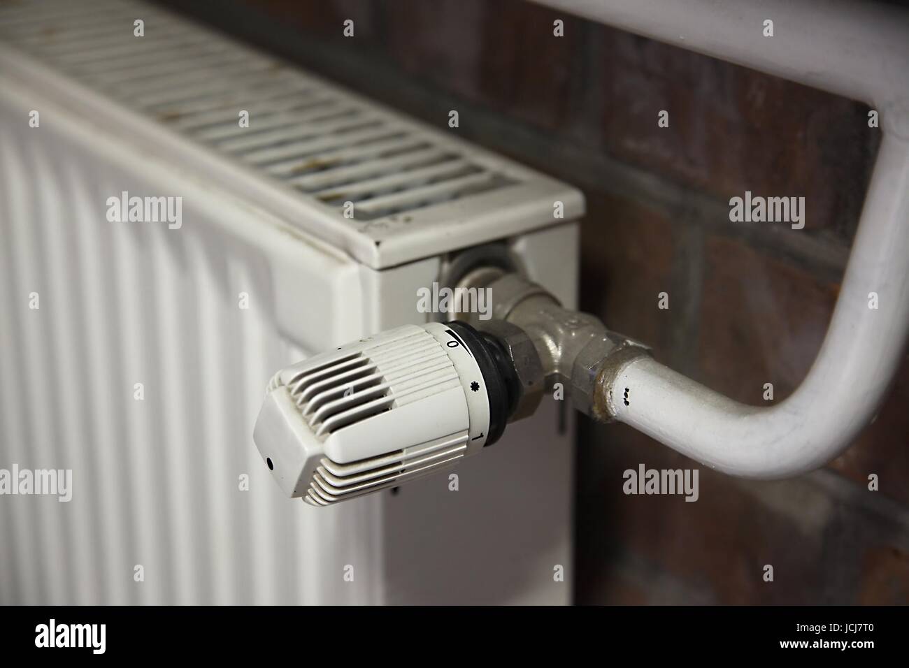 Heating radiator detail against orange wall Stock Photo - Alamy