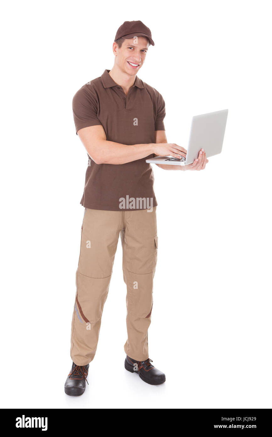 Young Delivery Man Using Laptop Over White Background Stock Photo - Alamy