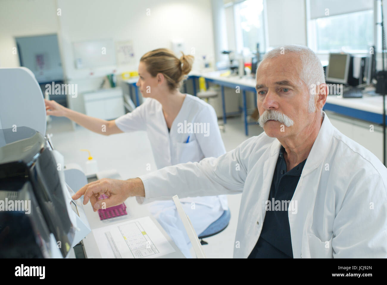 senior scientist looking at slide at the laboratory Stock Photo - Alamy