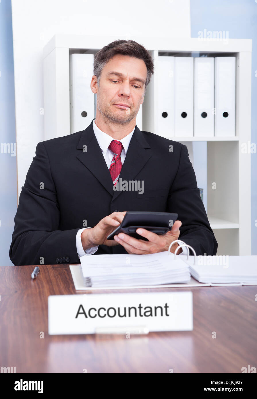Portrait Of Mature Male Accountant Working At Office Stock Photo - Alamy