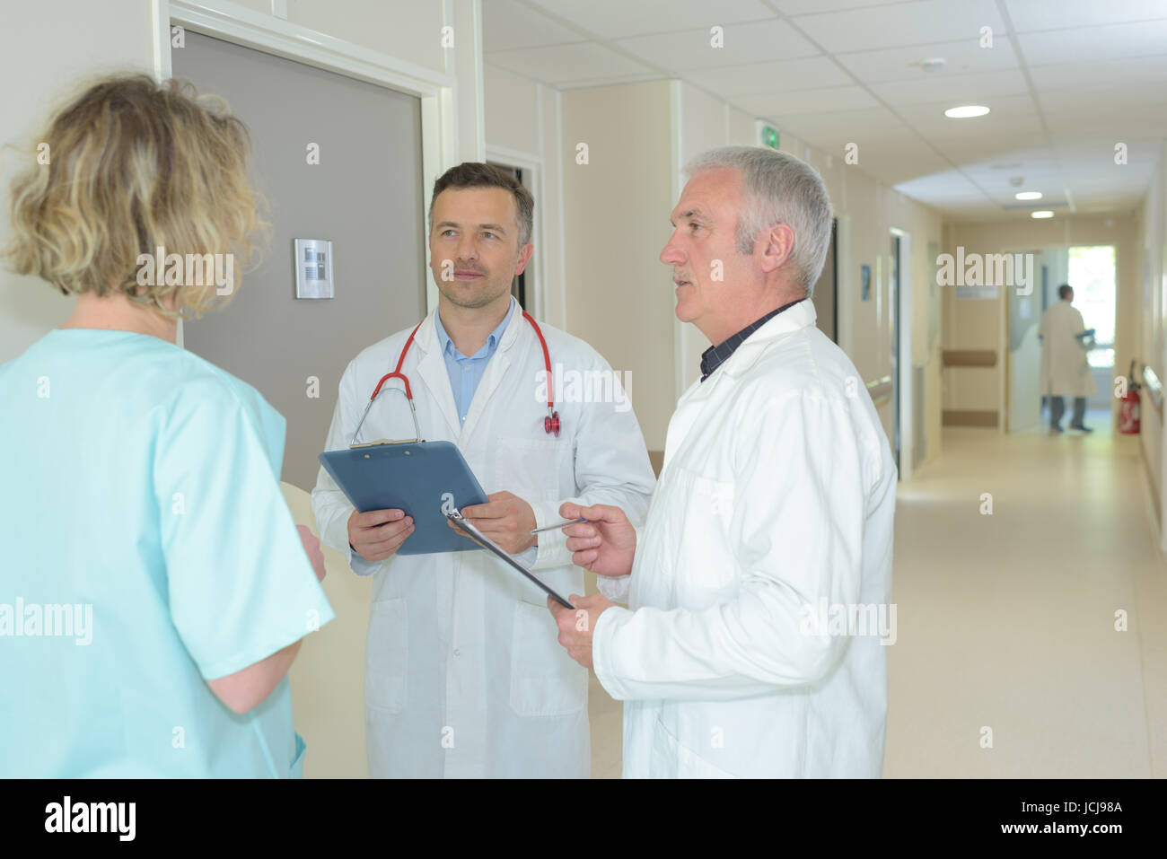 group of health employees discussing in hospitals corridor Stock Photo ...