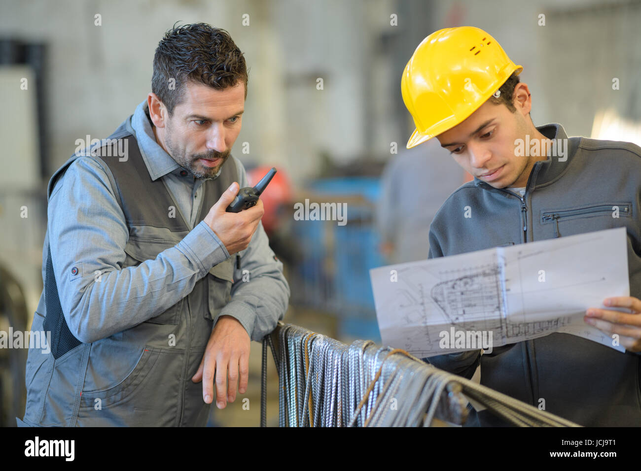foreman at work using a walkie talkie Stock Photo - Alamy