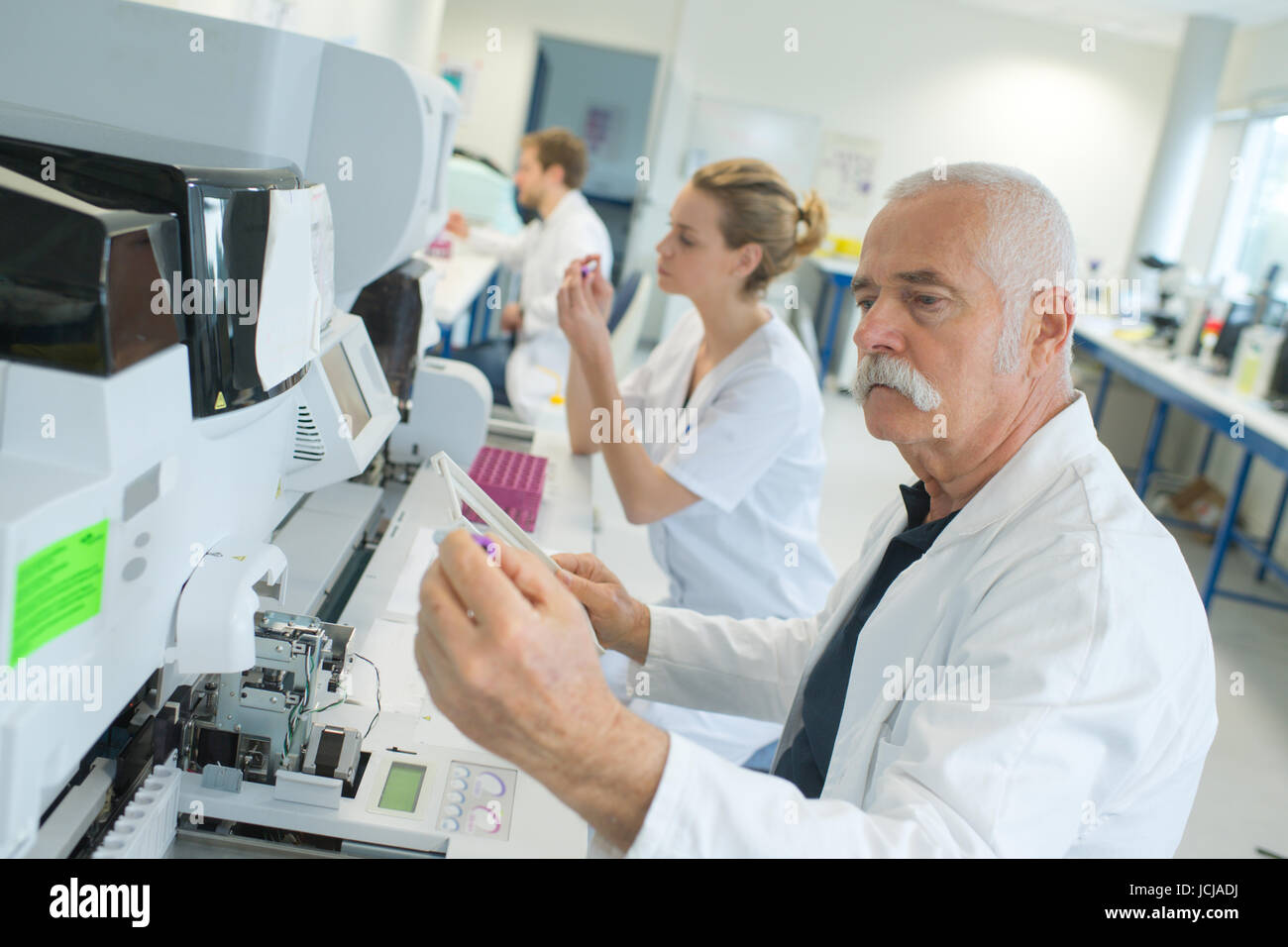 senior scientist looking at slide at the laboratory Stock Photo - Alamy