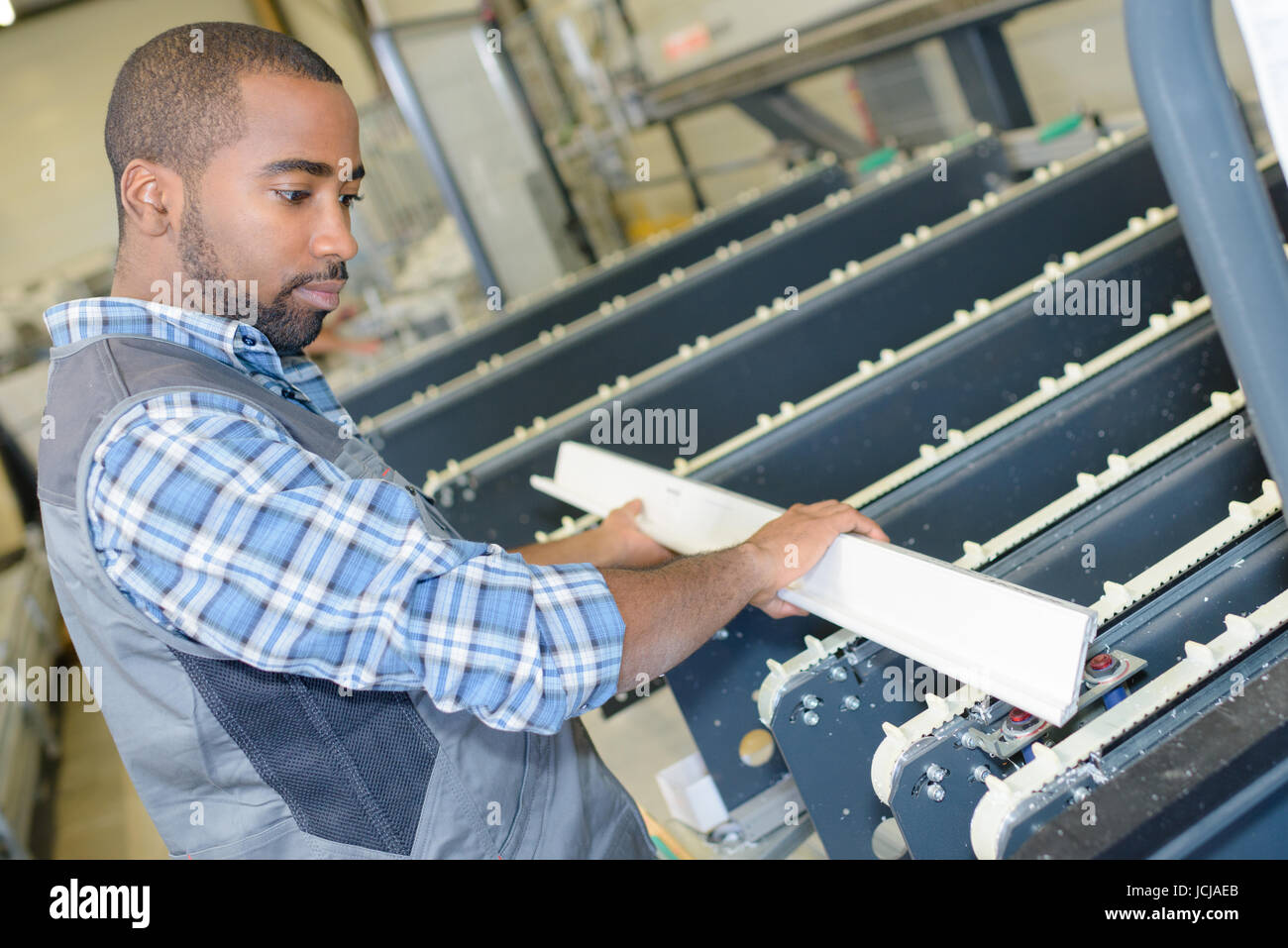 industrial worker manipulating metal board Stock Photo - Alamy