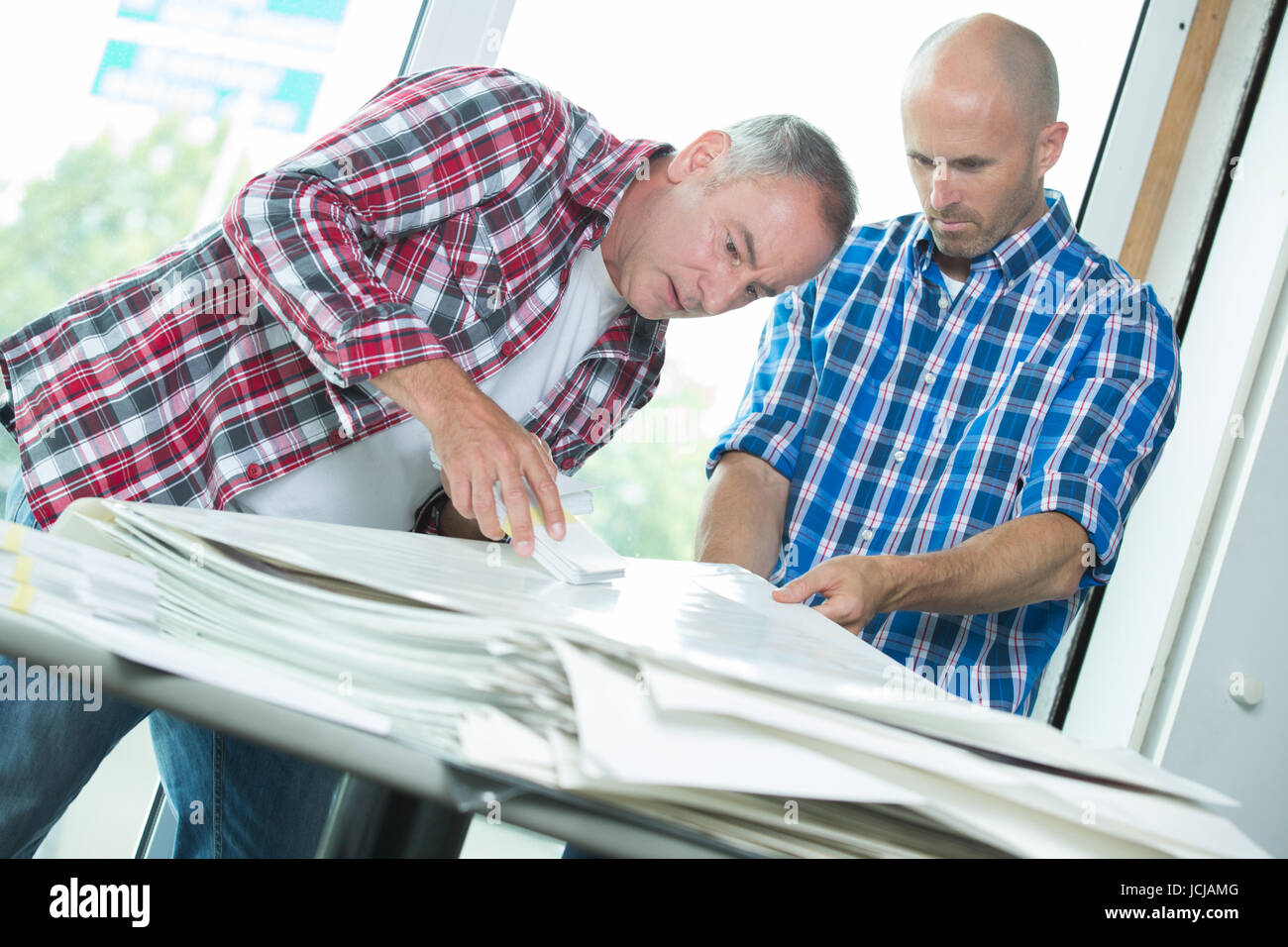 two builders working inside property Stock Photo - Alamy
