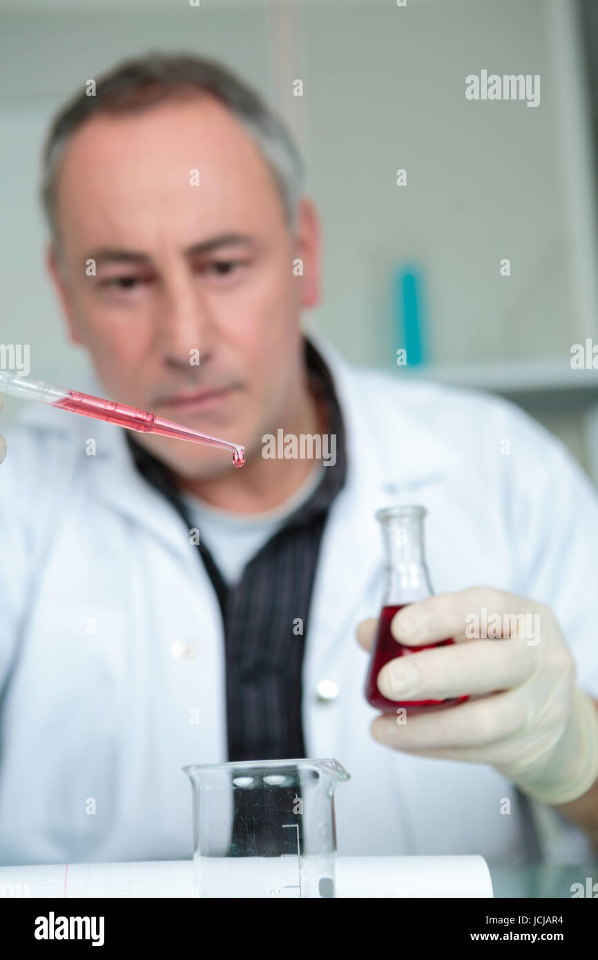 male scientist using chemistry fluid for research in laboratory Stock ...