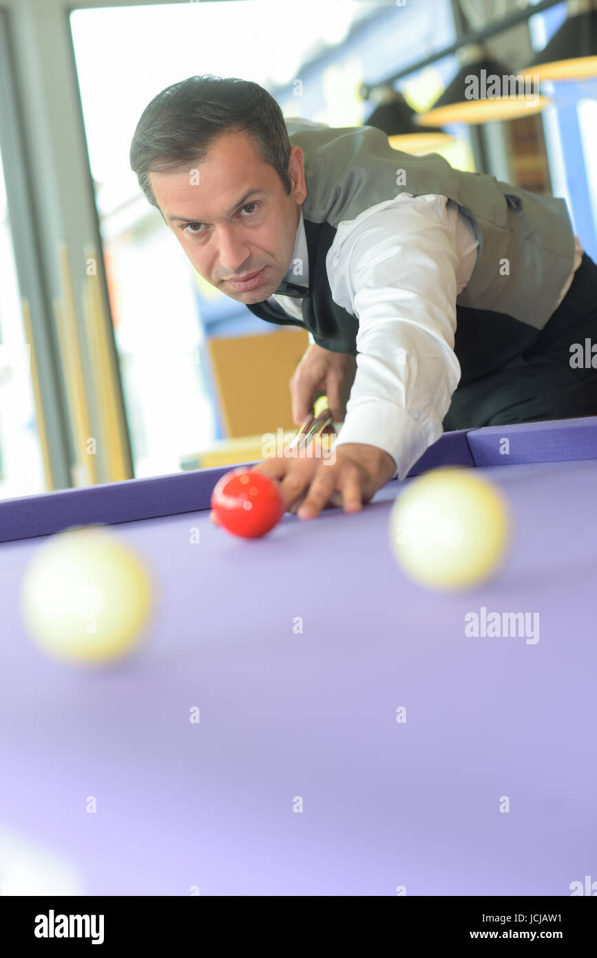 confident young man playing pool and looking concentrated Stock Photo ...