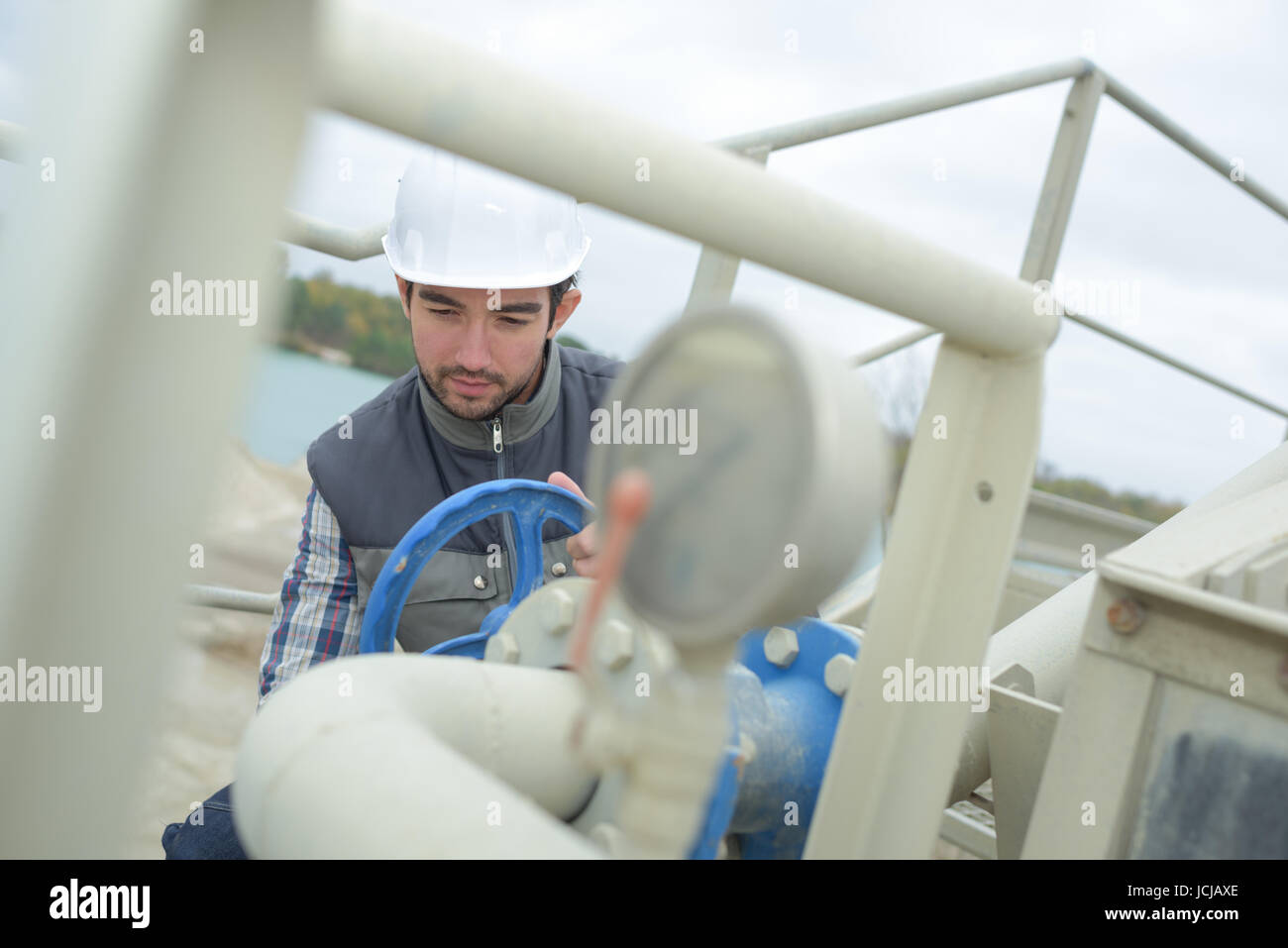 young handsome cement factory worker checking tanker valves Stock Photo ...