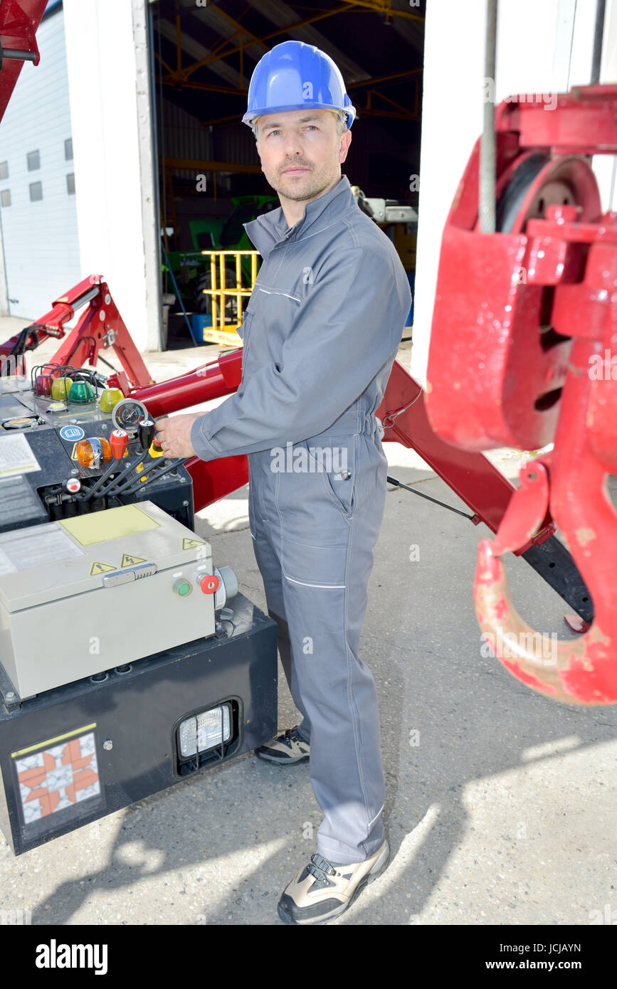 worker operating a crane at a construction site Stock Photo - Alamy