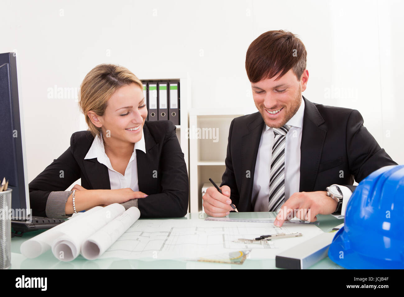 Attractive young architects working on their blueprint Stock Photo - Alamy
