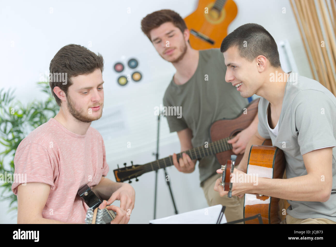 portrait of happyteenage band playing music together Stock Photo - Alamy