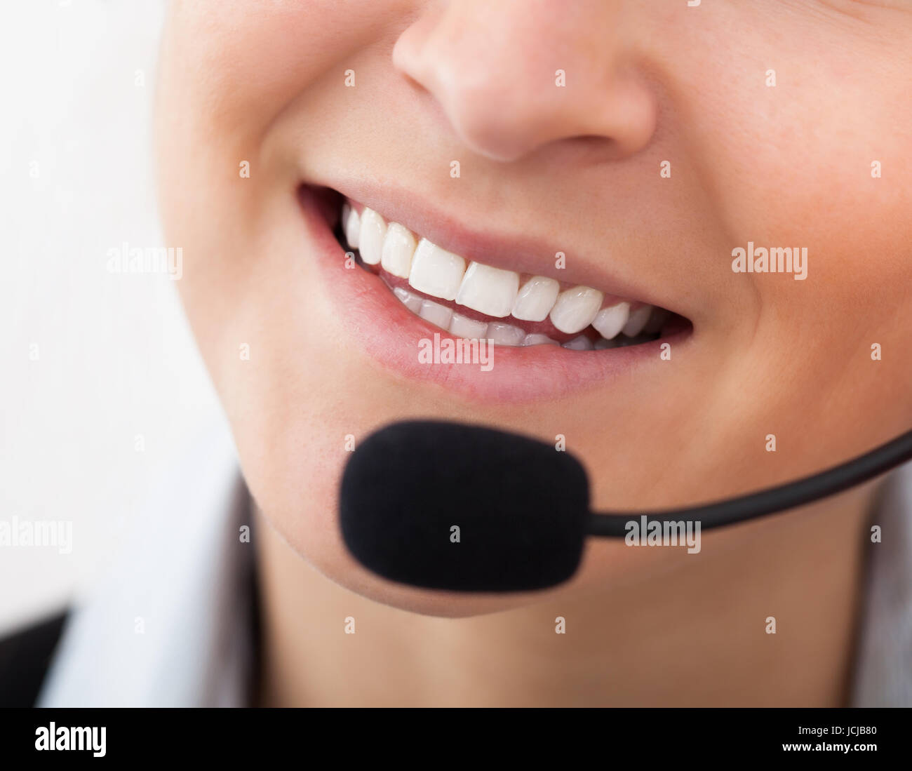 Portrait Of Happy Young Female Operator With Headphones Stock Photo - Alamy