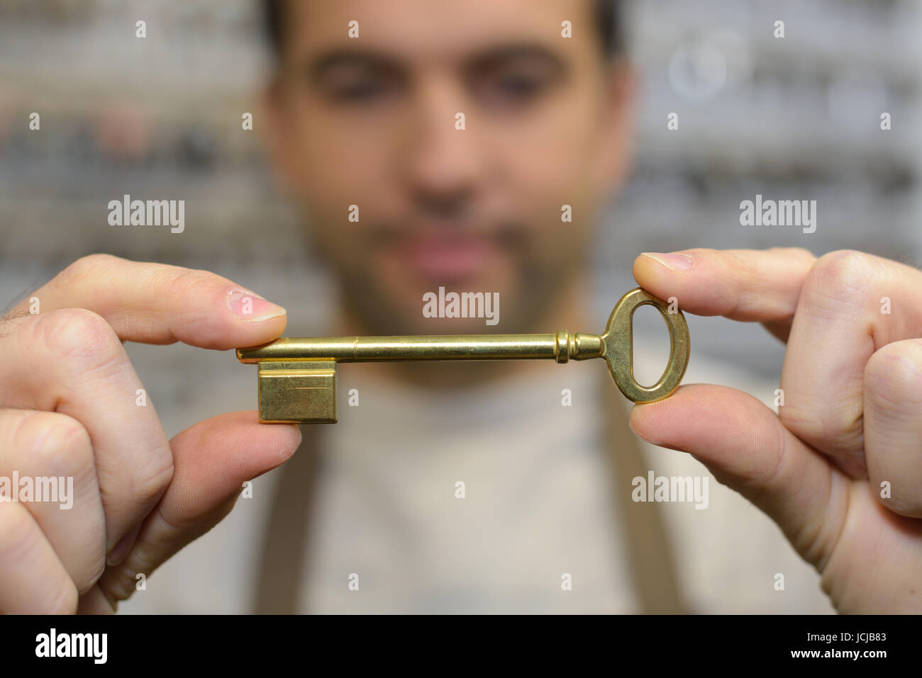 close up of locksmith hands holding key Stock Photo - Alamy