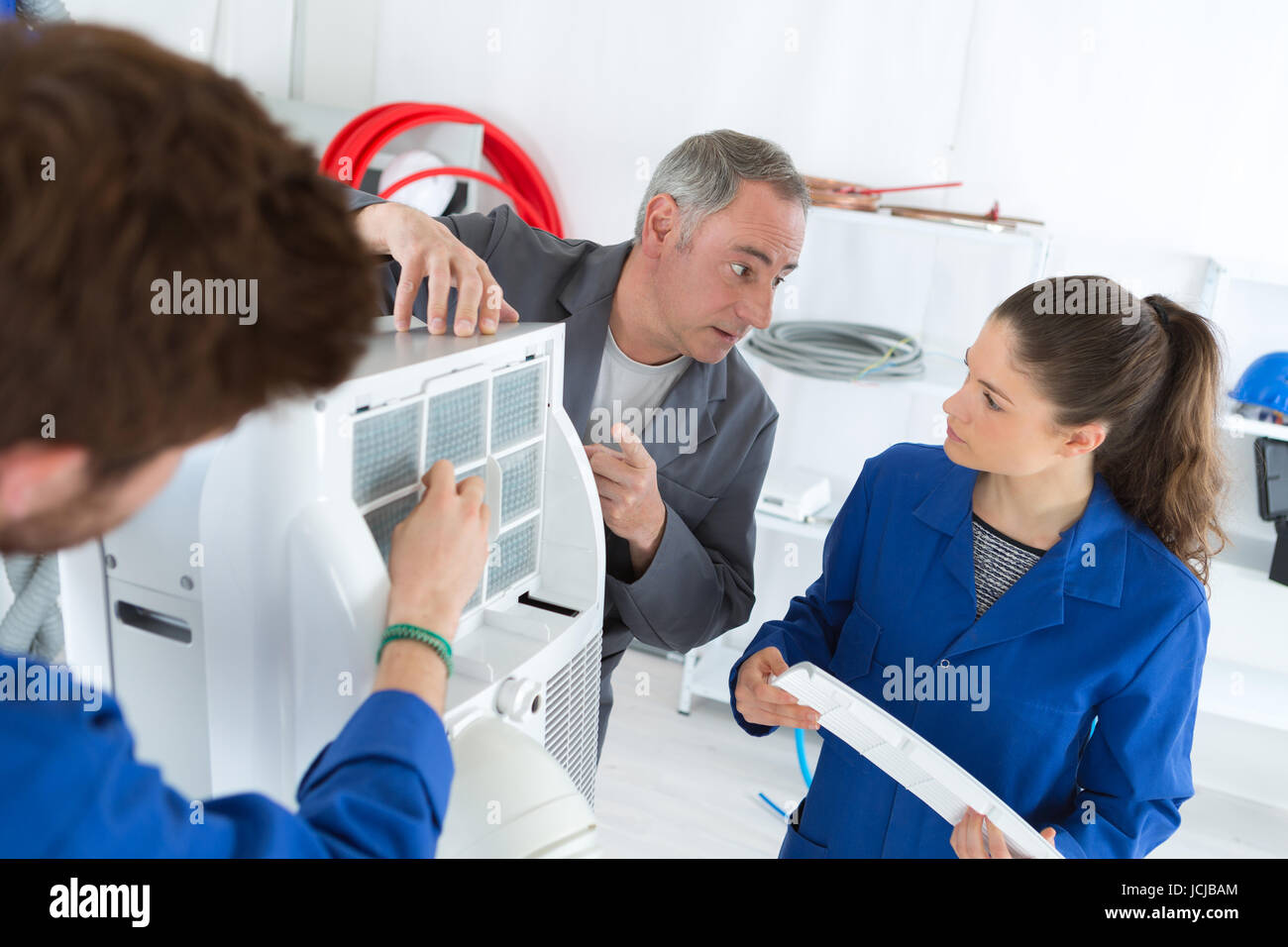 hvac repair technicians working on commercial heating air conditioning ...