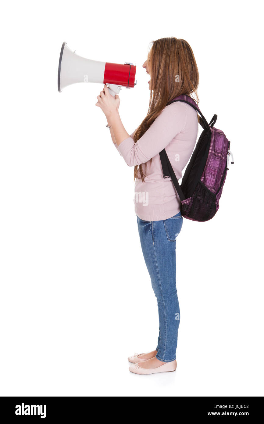 Young Female Student Shouting In Megaphone Over White Background Stock ...