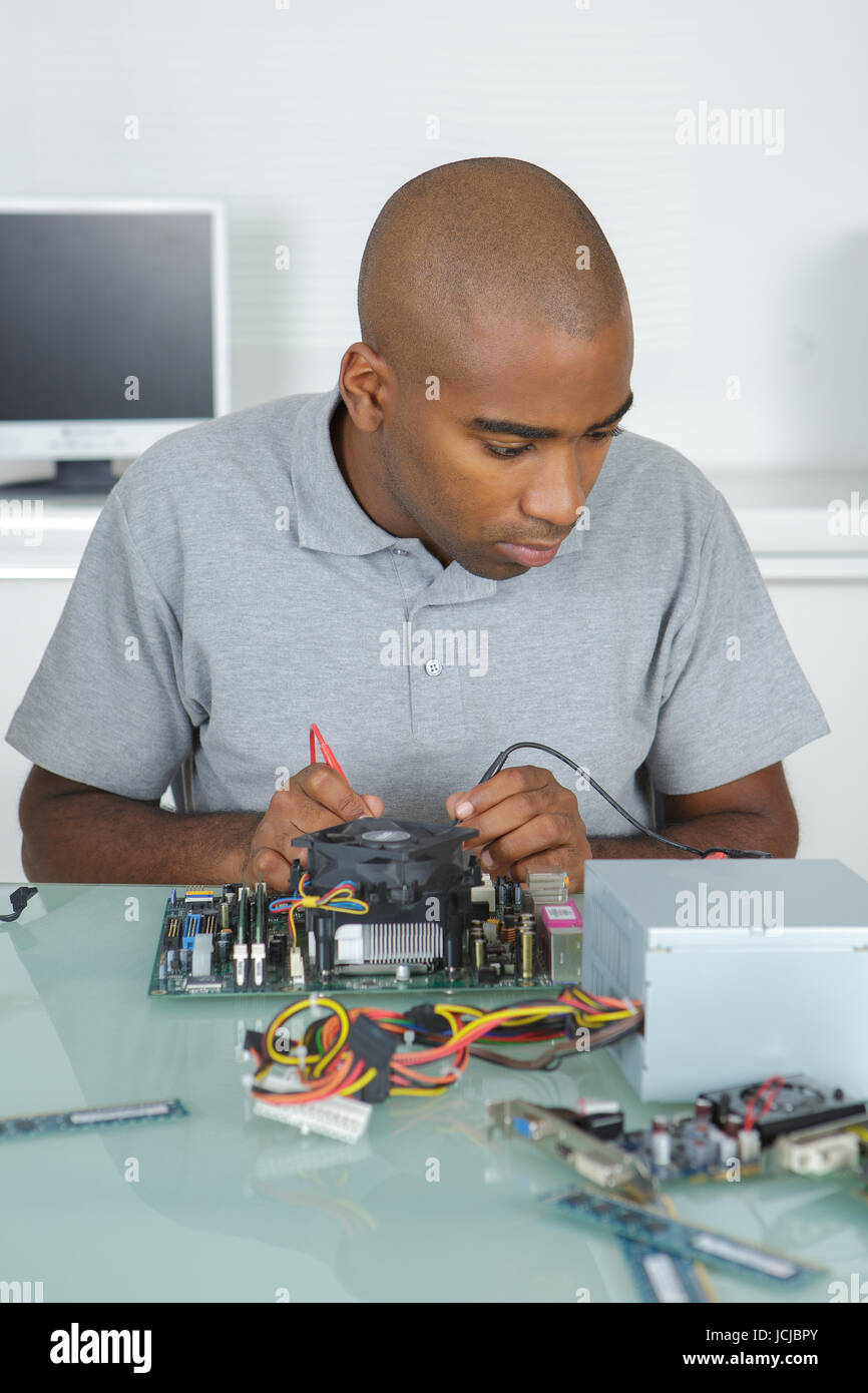 Repairman soldering electronic components hi-res stock photography and ...