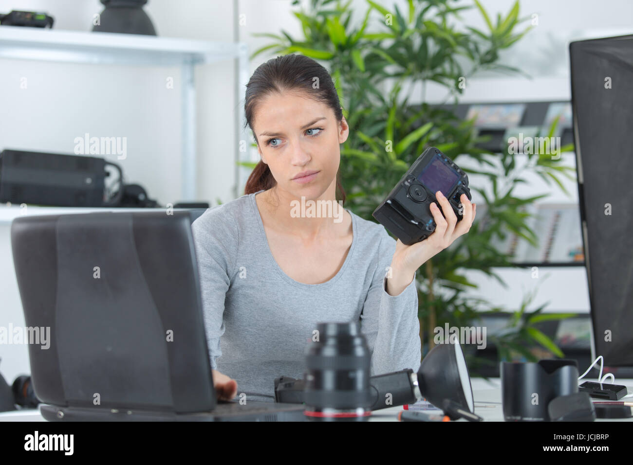 tired photographer working at her workplace Stock Photo - Alamy