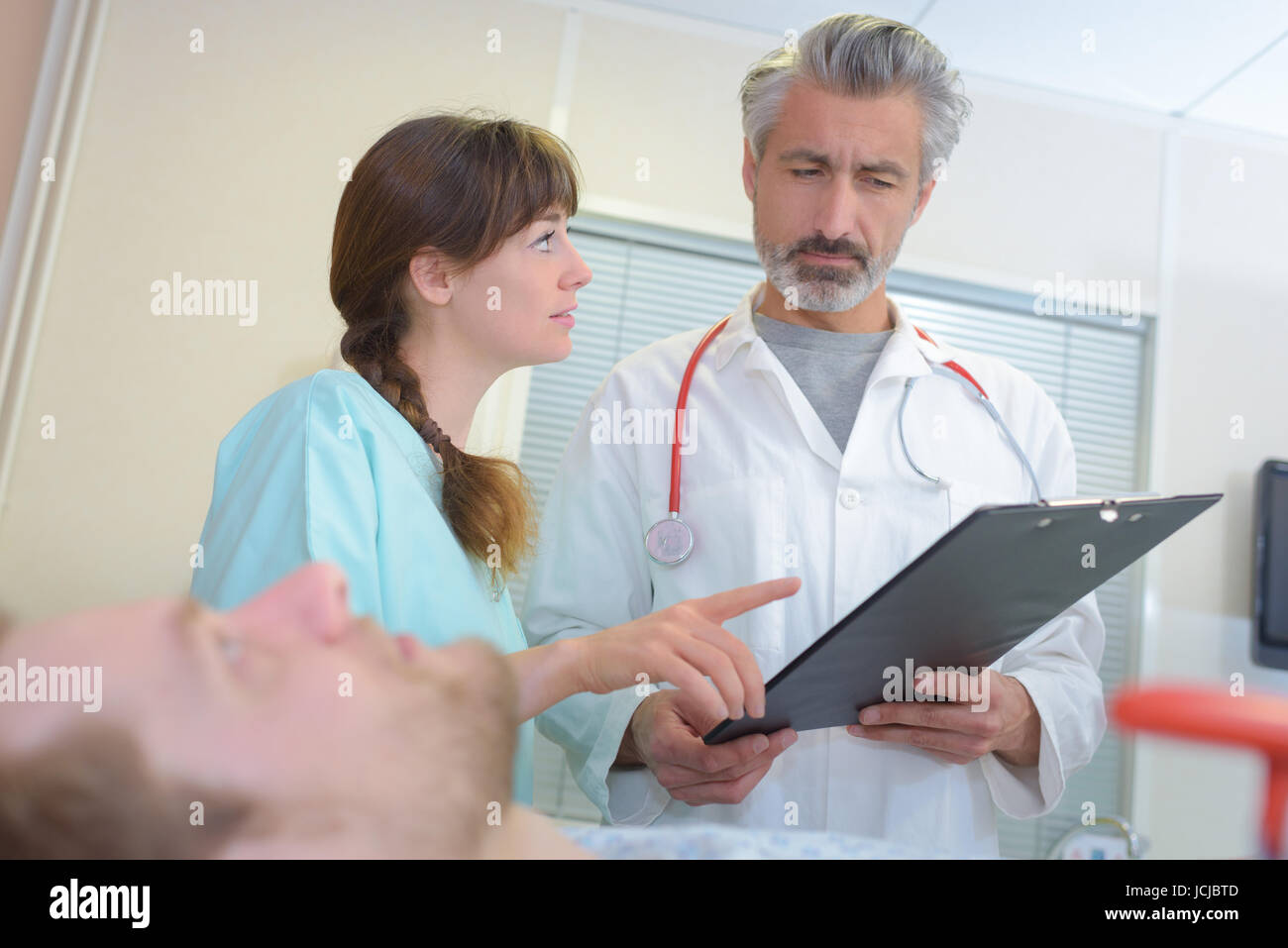 octor and nurse with patient in hospital Stock Photo - Alamy