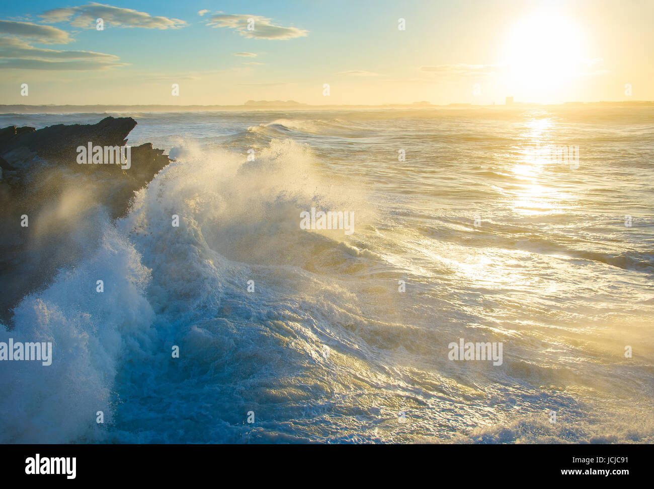 Wave crashing of a rocky beach at sunset. Portugal Stock Photo - Alamy
