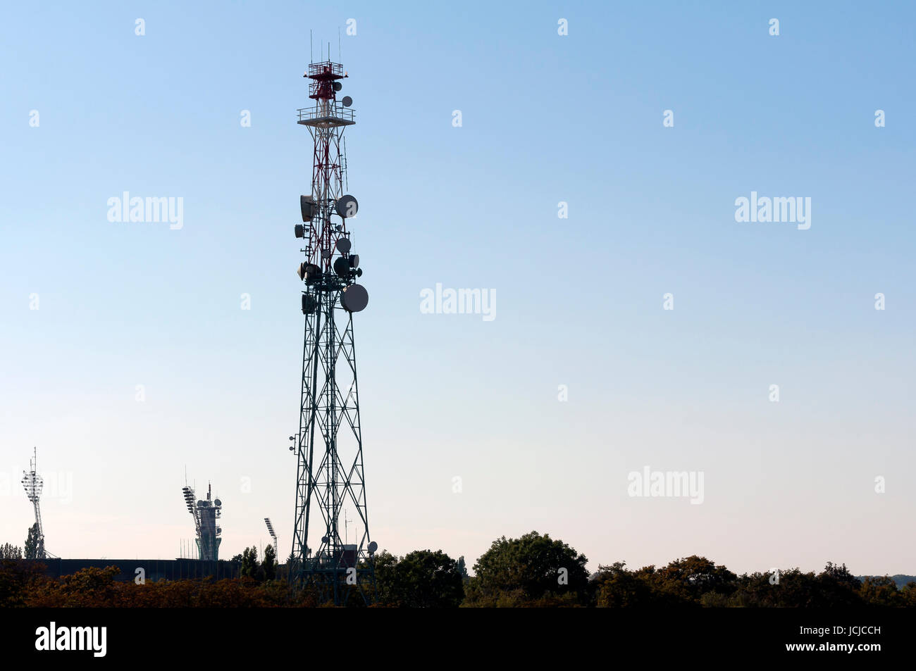 Telecommunications tower with antennas under blue sunset skies Stock ...