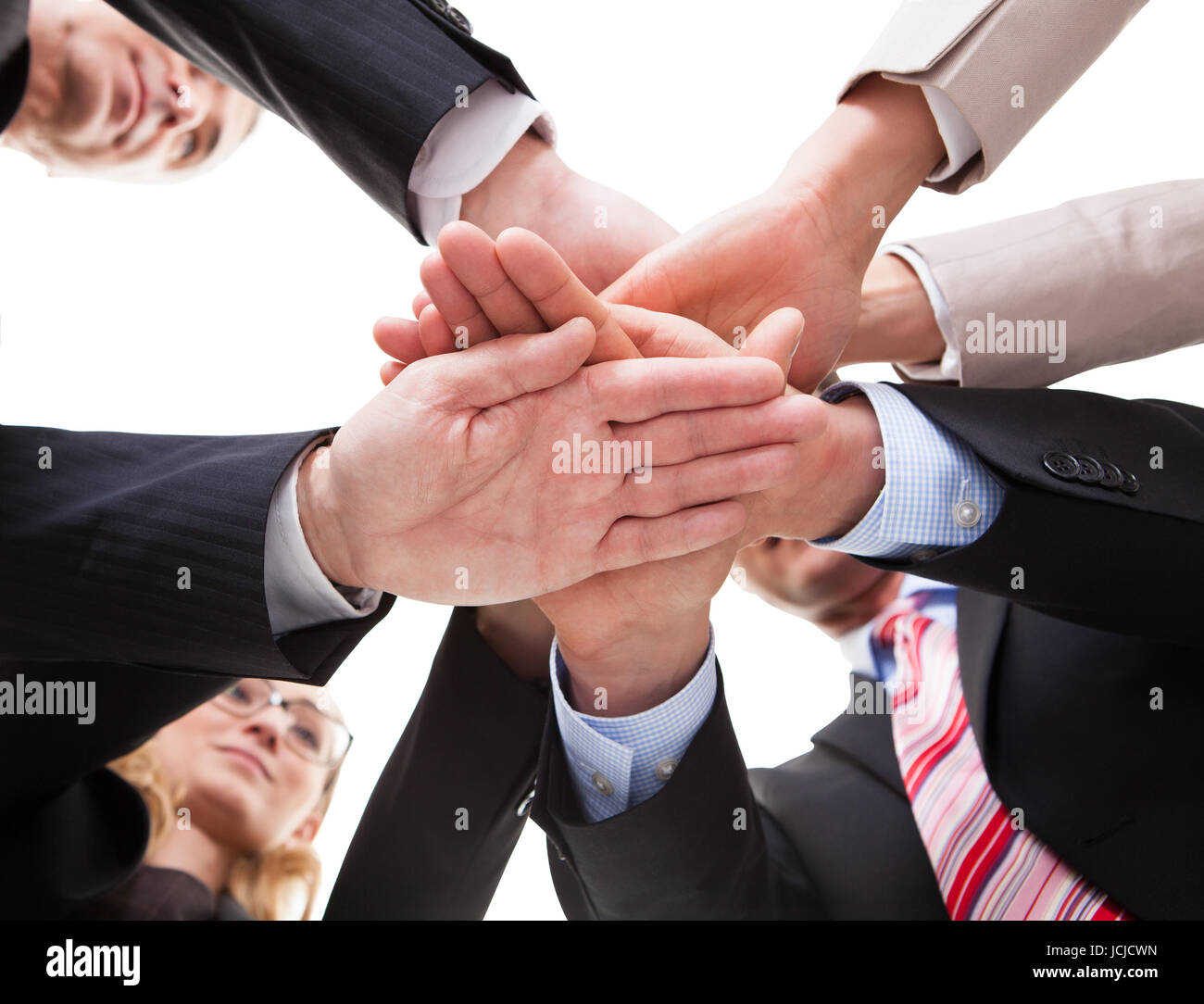View from underneath of a group of businesspeople standing in a circle ...