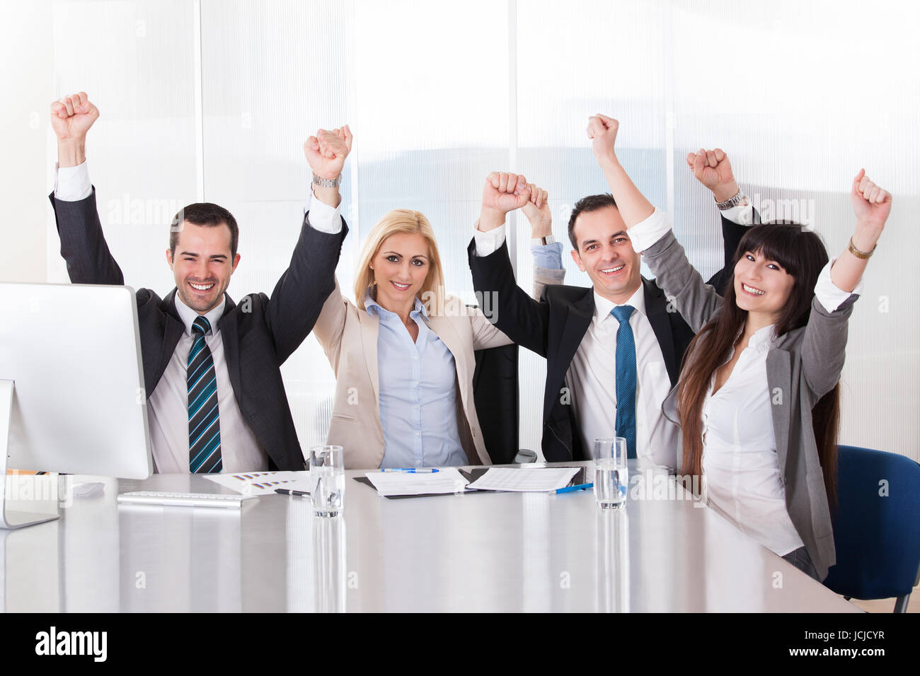 Happy Business Team In Office Celebrating Success Stock Photo - Alamy