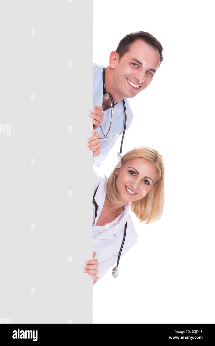 Two Happy Doctors With Placard Over White Background Stock Photo - Alamy