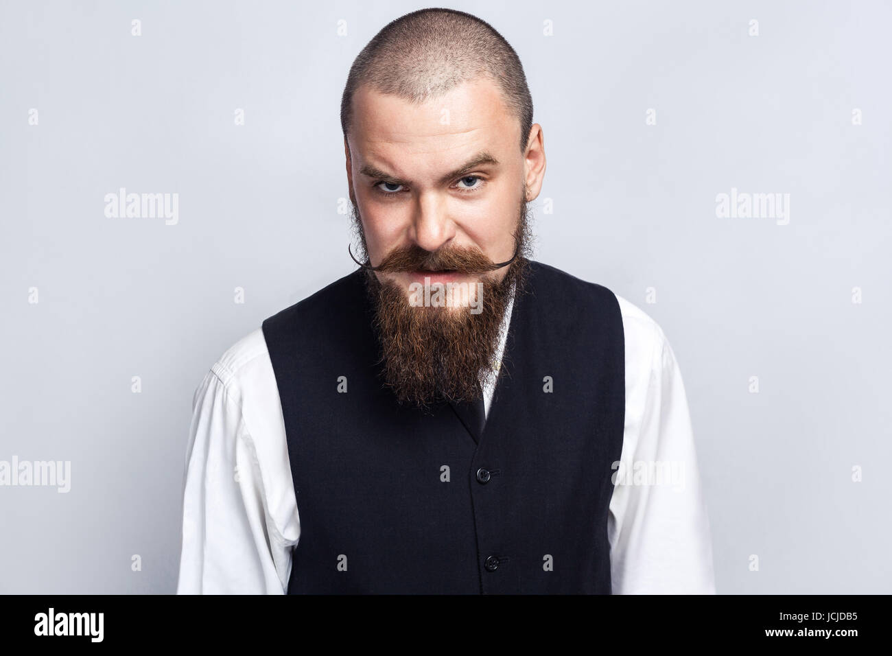 Angry. Handsome businessman with beard and handlebar mustache looking ...