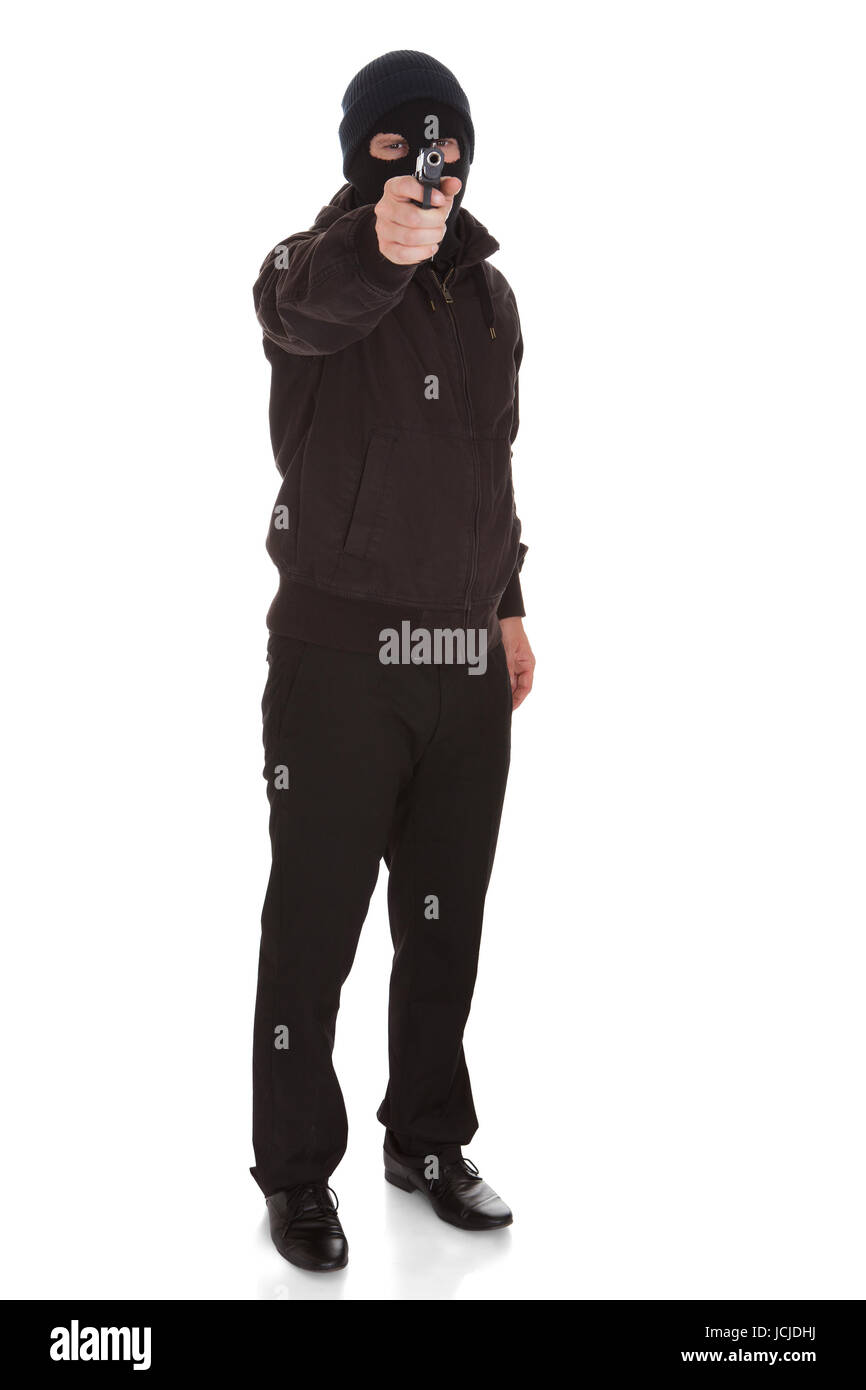Burglar Wearing Mask Aiming Gun Towards Camera Stock Photo - Alamy