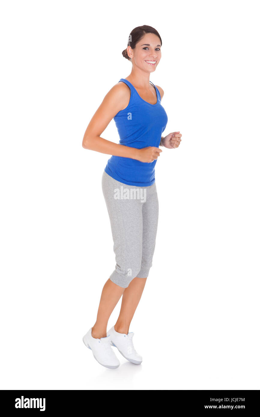 Happy Young Woman Jogging Over White Background Stock Photo - Alamy