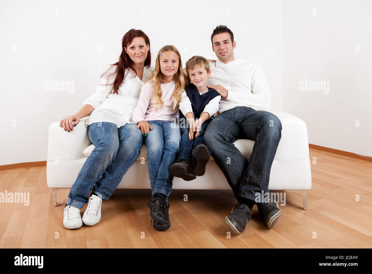 Portrait of happy family with their children at home Stock Photo - Alamy