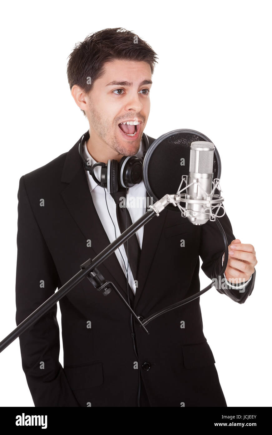 Young singer and microphone. Isolated on white Stock Photo - Alamy