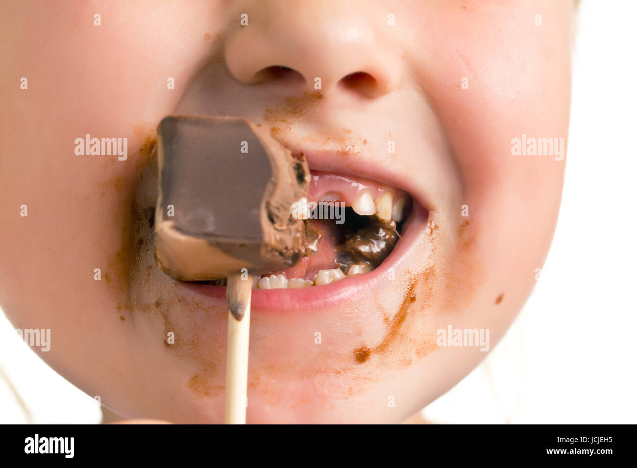 the child eating chocolate lollipop Stock Photo - Alamy