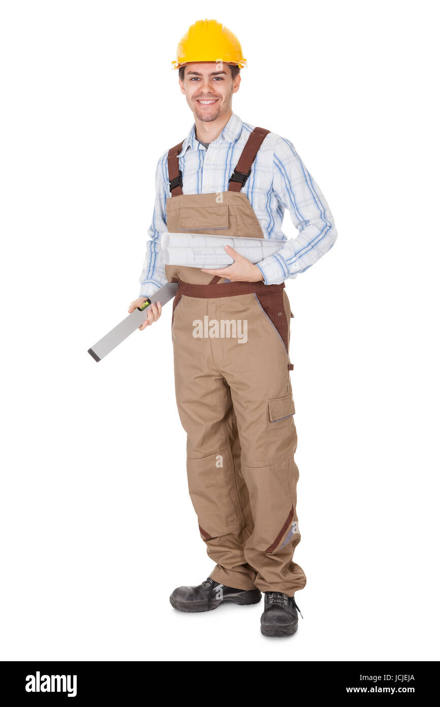 Smiling handsome handyman in work clothes with tool Stock Photo - Alamy
