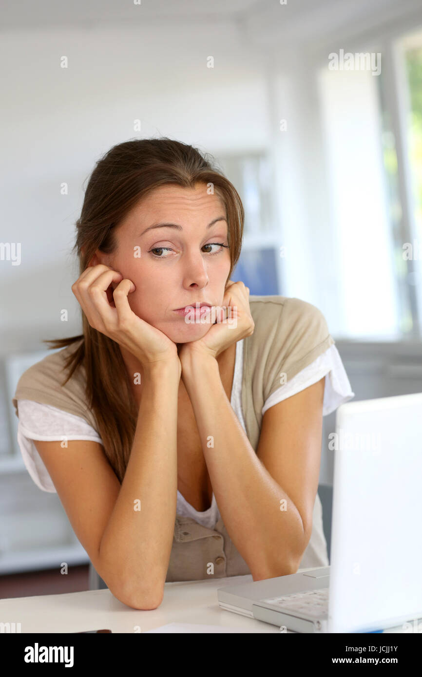 Home office worker with upset look on her face Stock Photo - Alamy