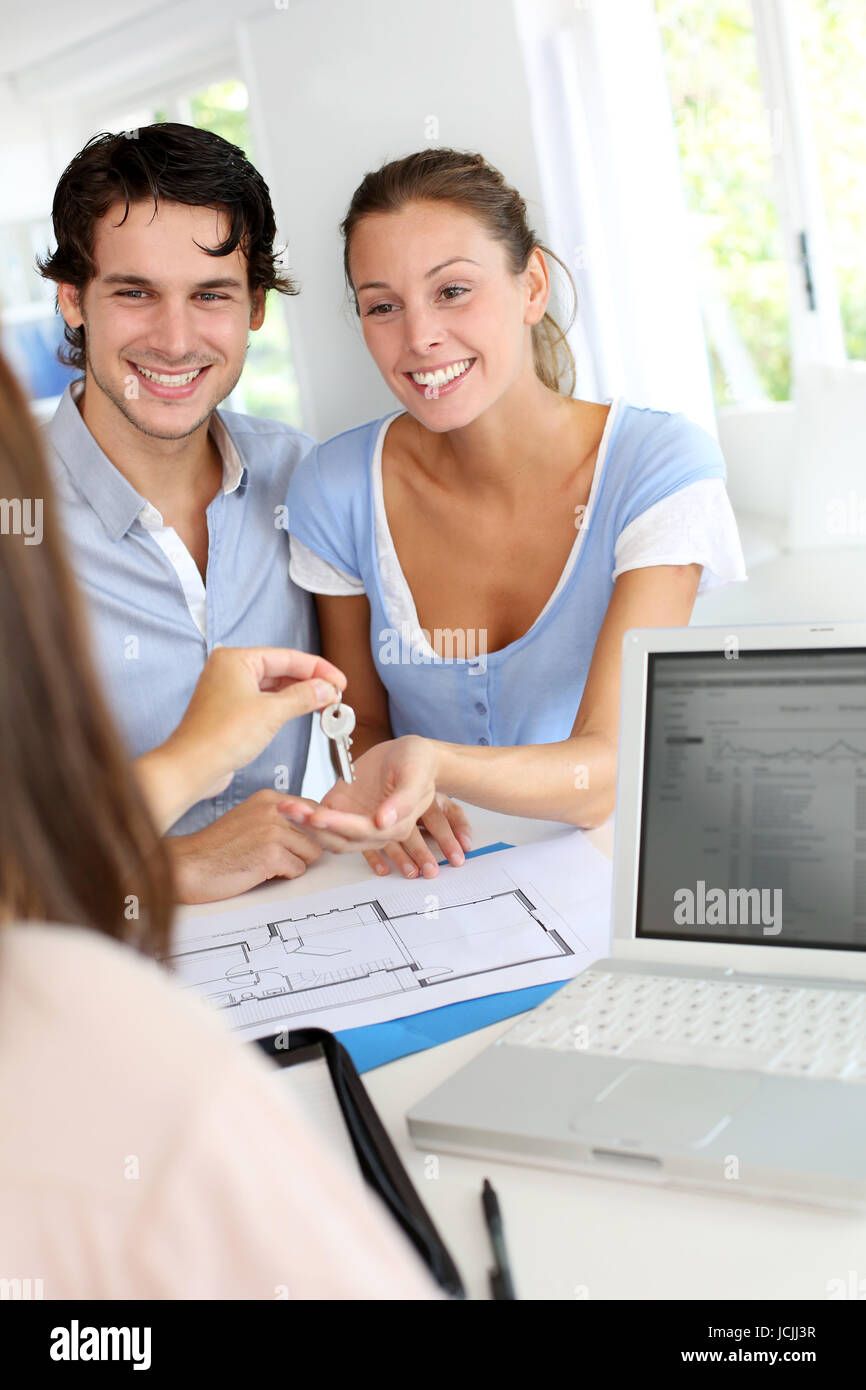 Couple receiving keys of their home Stock Photo - Alamy