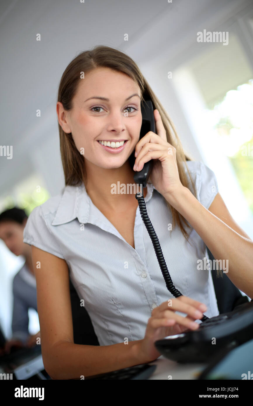 Beautiful office worker talking on the phone Stock Photo - Alamy