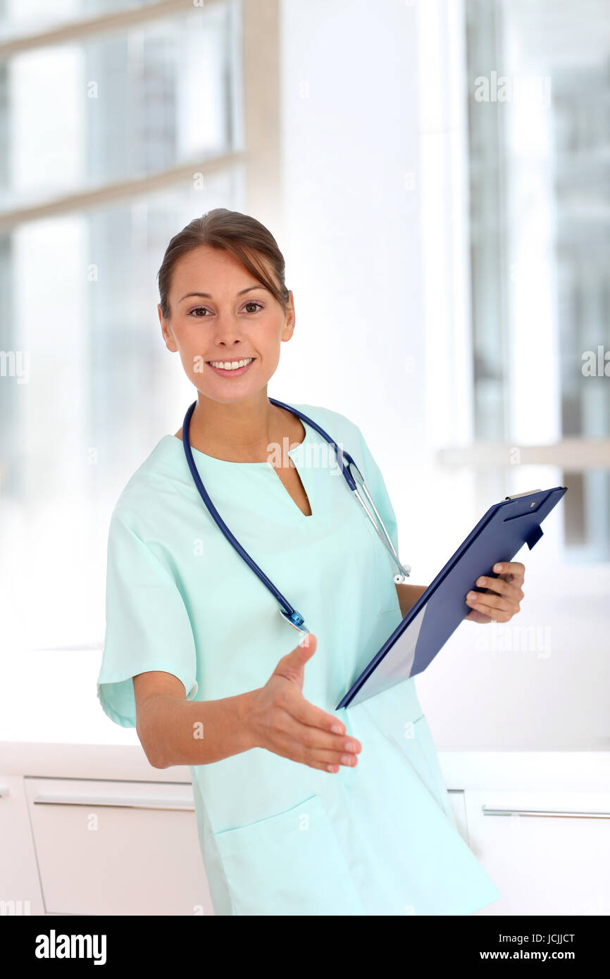 Beautiful nurse giving handshake to patient's family Stock Photo - Alamy