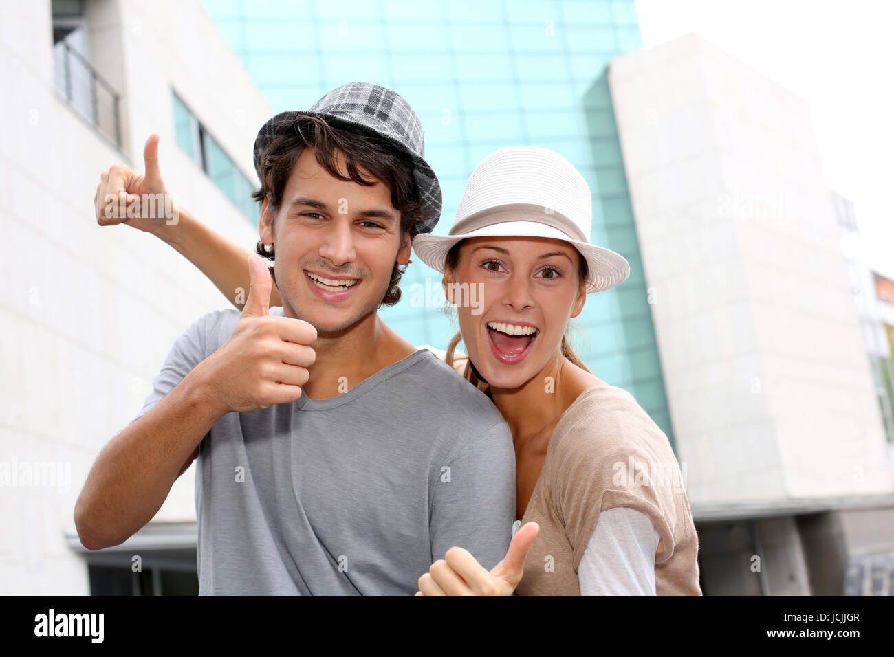 Happy friends showing thumbs up Stock Photo - Alamy