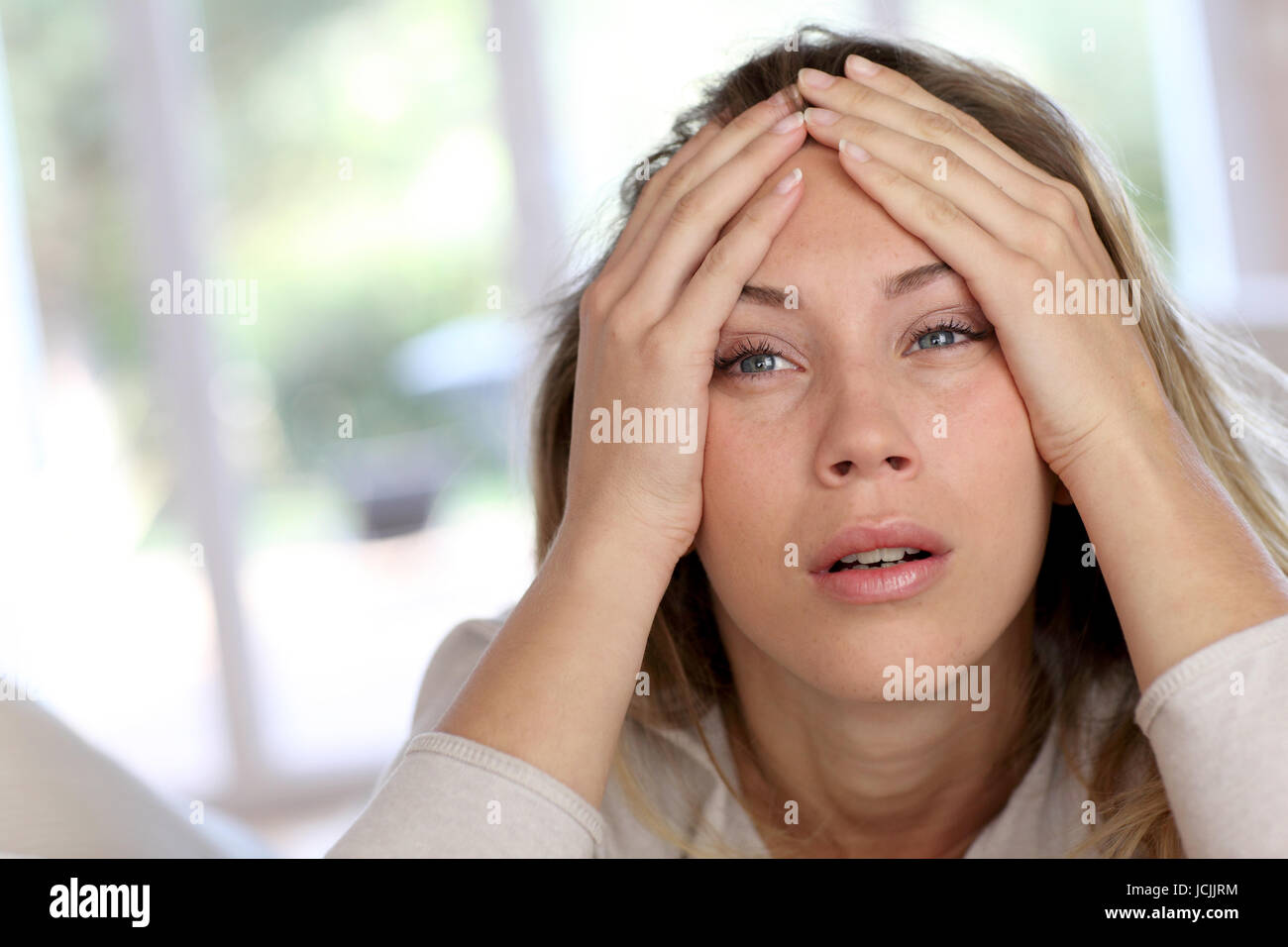 Portrait of blond woman with boring look Stock Photo - Alamy