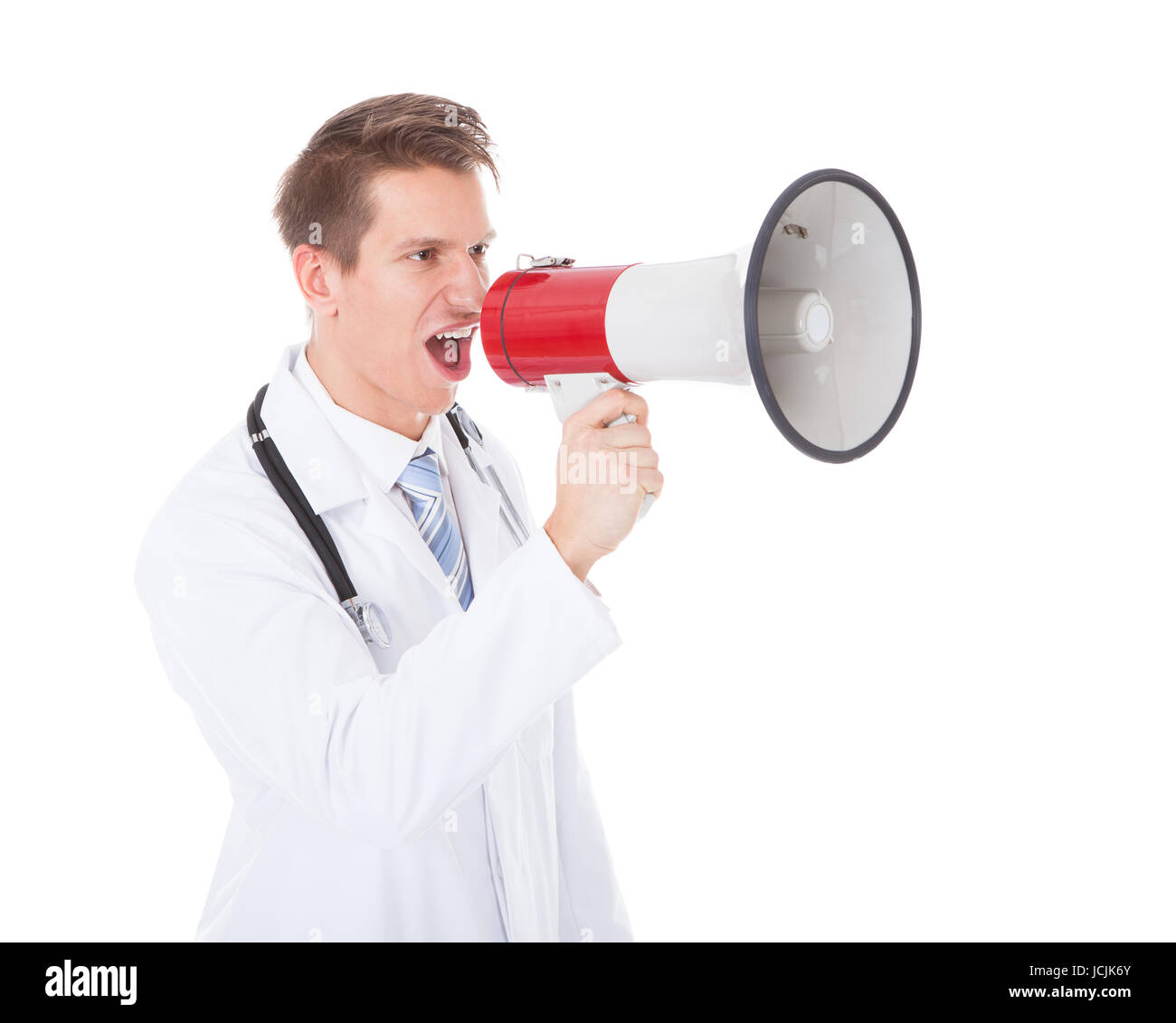 Male Doctor Shouting Through Megaphone Over White Background Stock ...